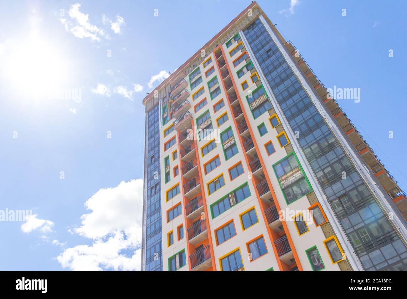 A high-rise building against a blue sky. A new high-rise residential ...