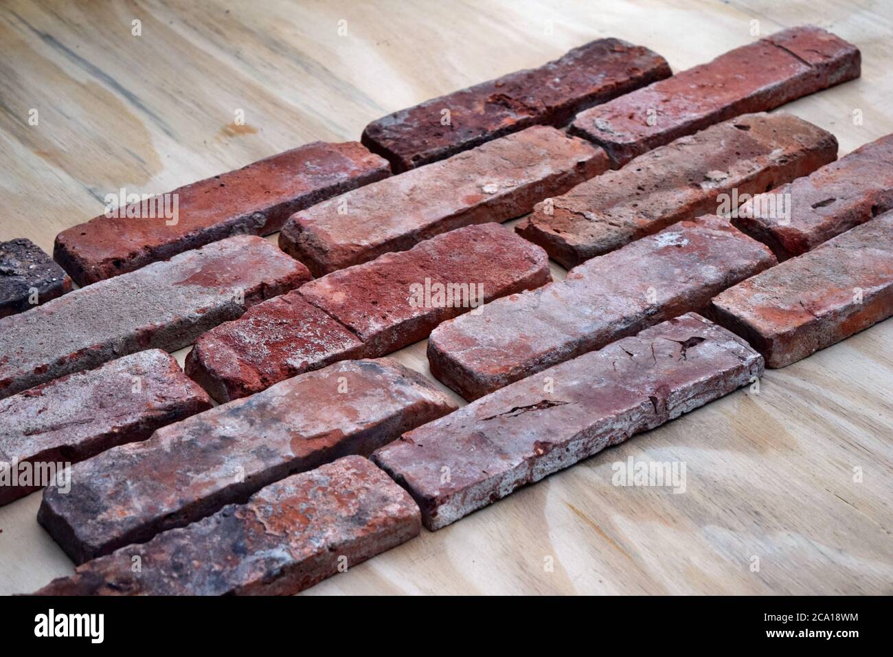 Cut red bricks range prepared to use design in the wall Stock Photo - Alamy