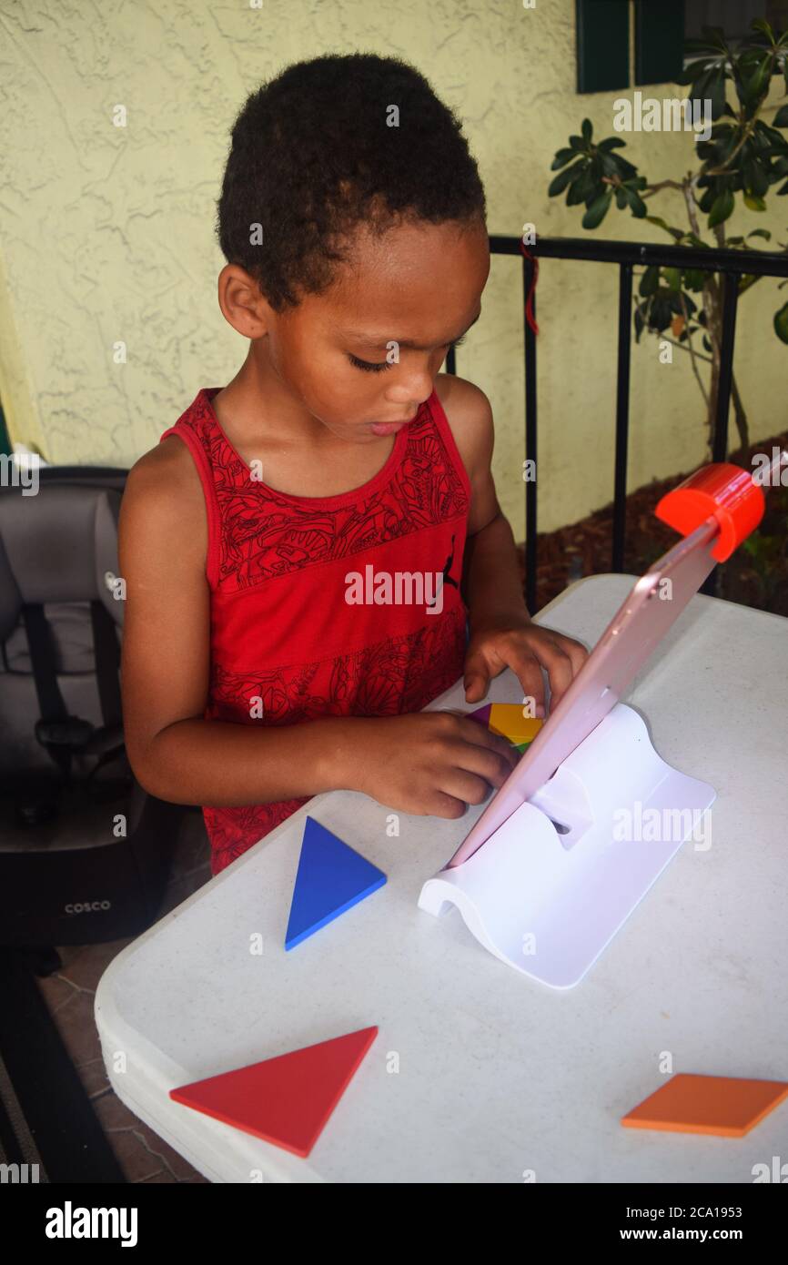 Young preschool black boy on Ipad Stock Photo - Alamy