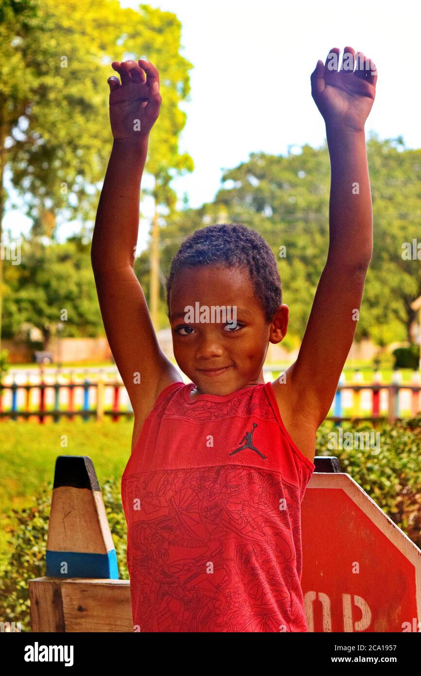 Young black boy with hands up Stock Photo - Alamy