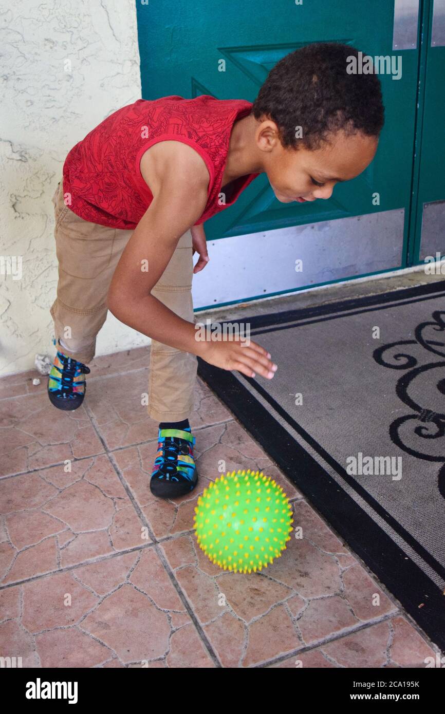 Child bouncing ball hi-res stock photography and images - Alamy