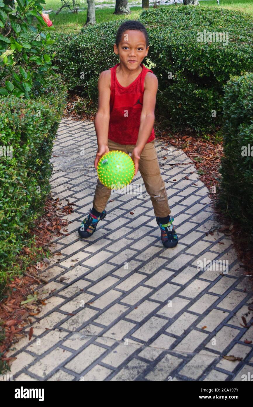 Boy playing outside hi-res stock photography and images - Alamy
