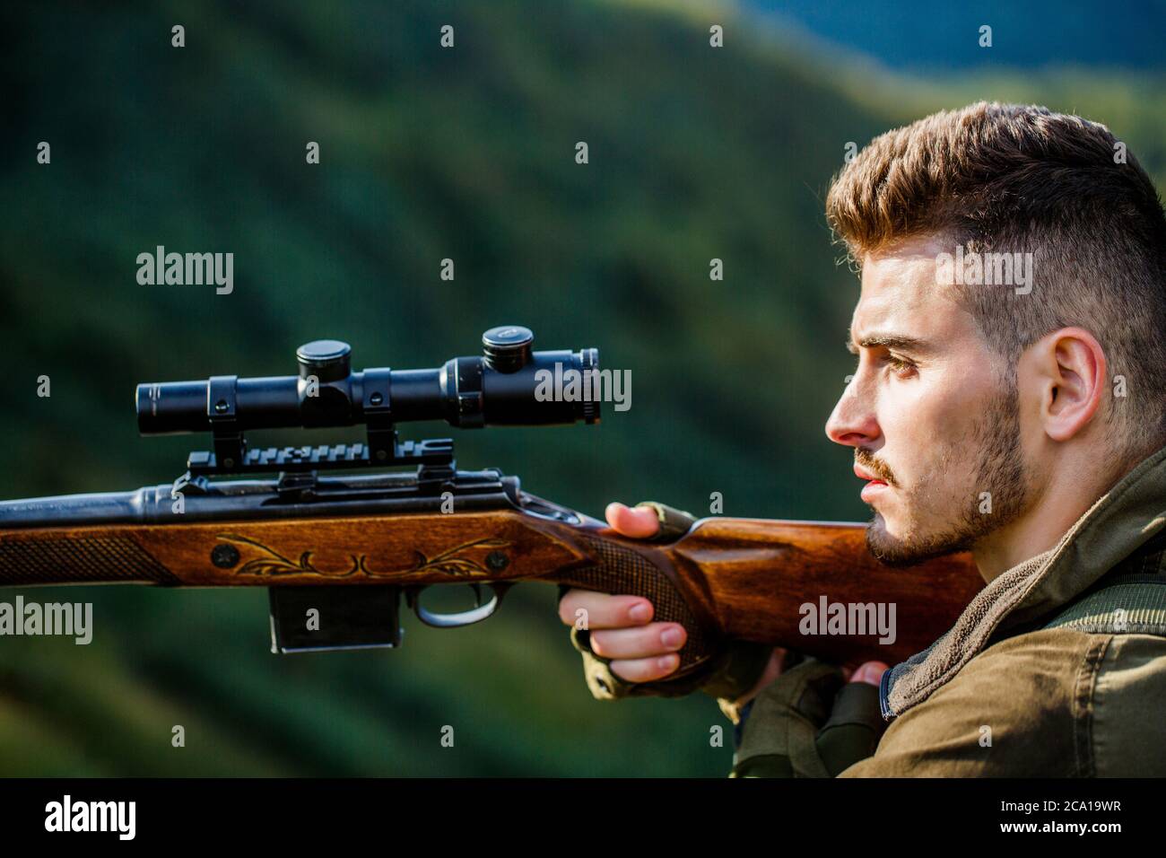 Hunter man. Shooter sighting in the target. Hunting period. Male with a ...