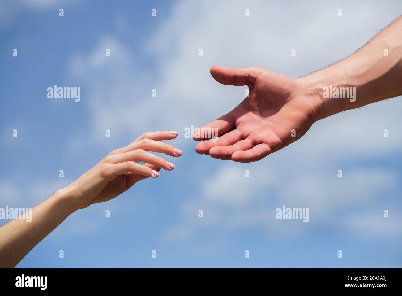 Hands of man and woman reaching to each other, support. Giving a helping hand. Hands of man and ...