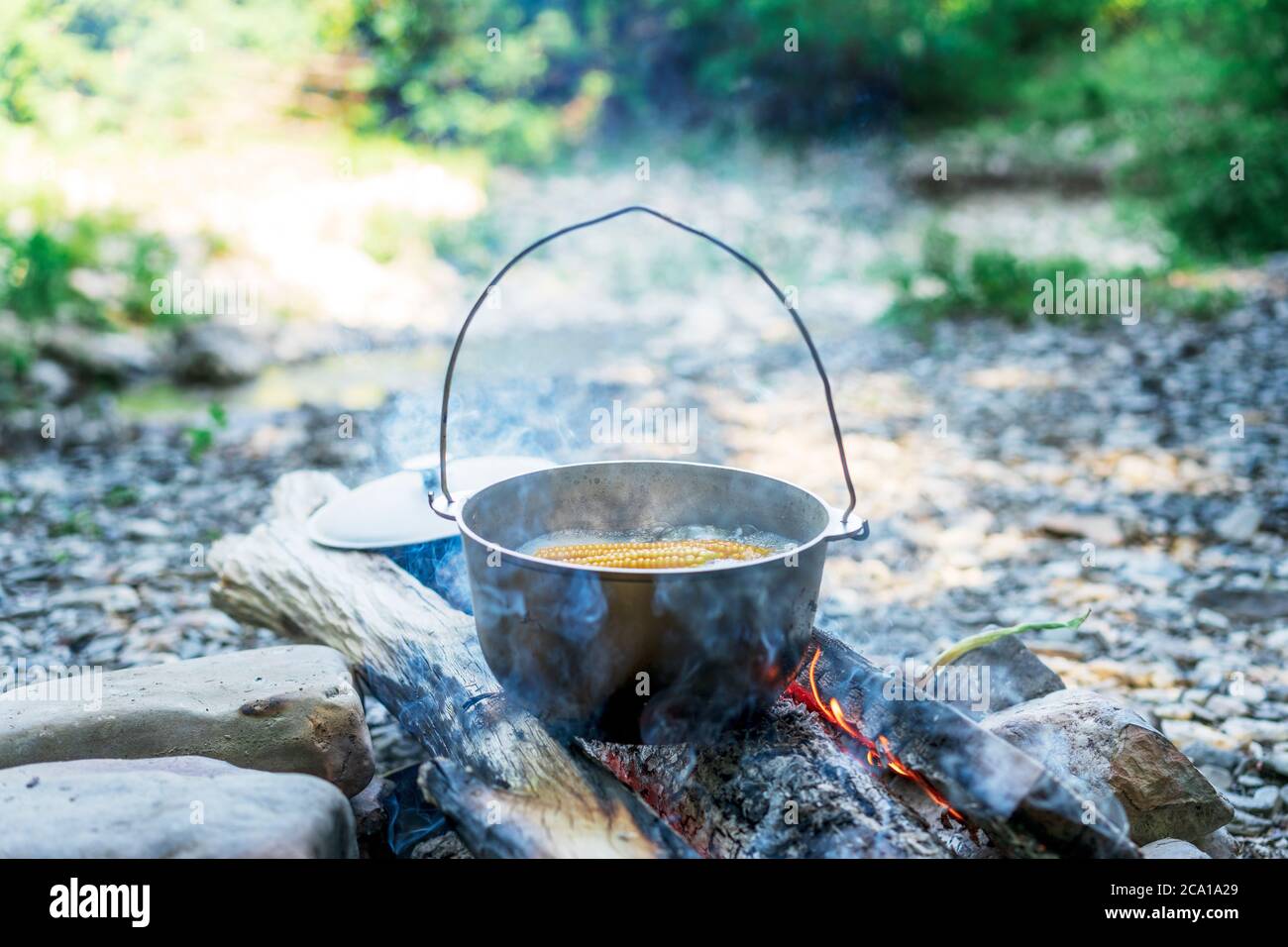 Traveling, tourism, picnic cooking, cooking in a cauldron on the fire ...