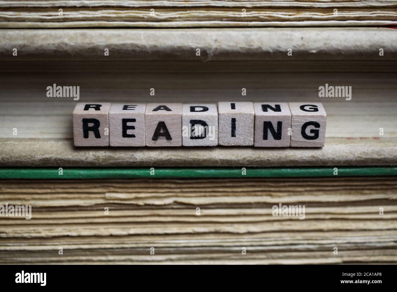 Closeup of isolated antique old book pile text blocks and yellowed ...