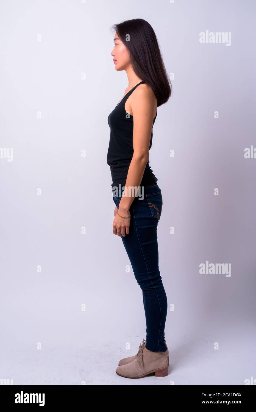 Full body shot profile view of young beautiful Asian woman Stock Photo ...