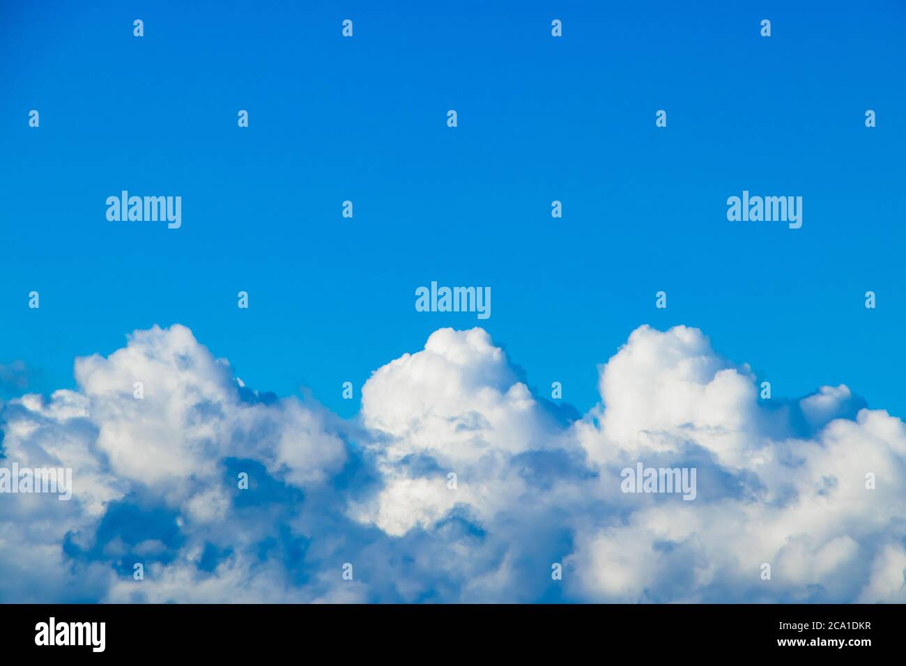 Pure fluffy white clouds on a blue sky. A symbol of purity and dreams ...