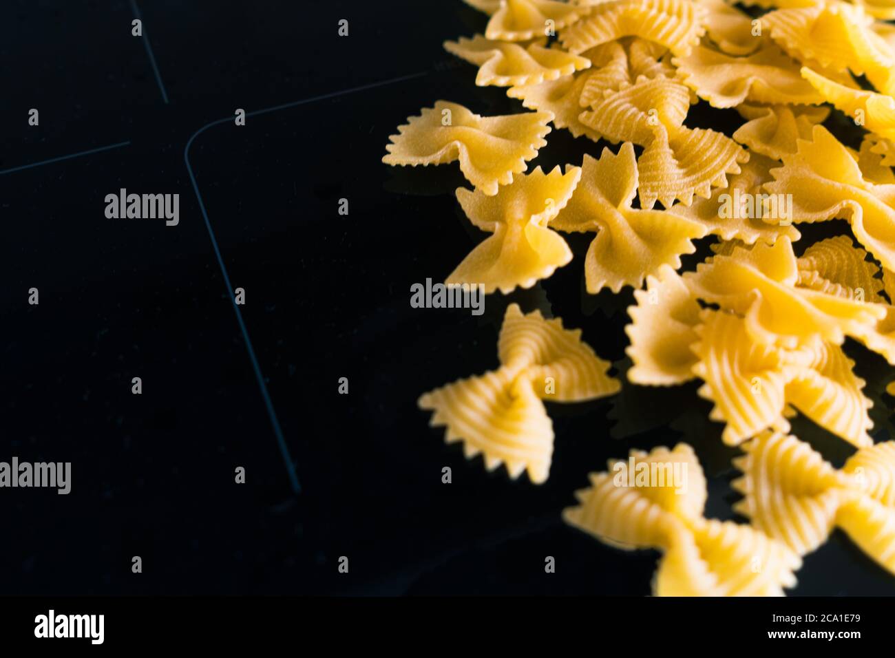 Pasta on modern black induction stove, stove, hob with ceramic plate in ...