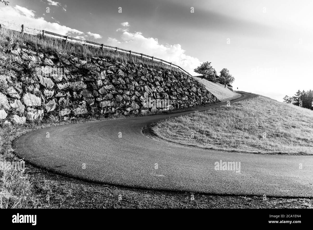 Sharp hairpin curve of narrow rural asphalt road in the mountains ...