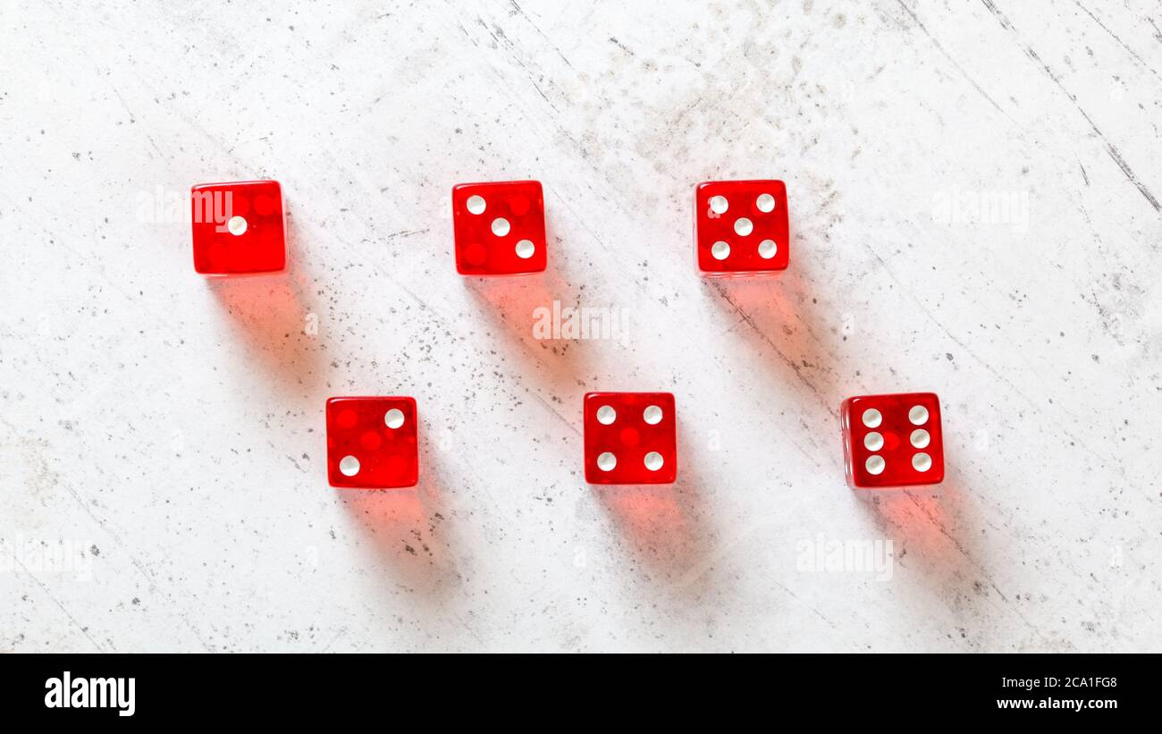 Red translucent craps dices on white board, showing all numbers from 1 ...