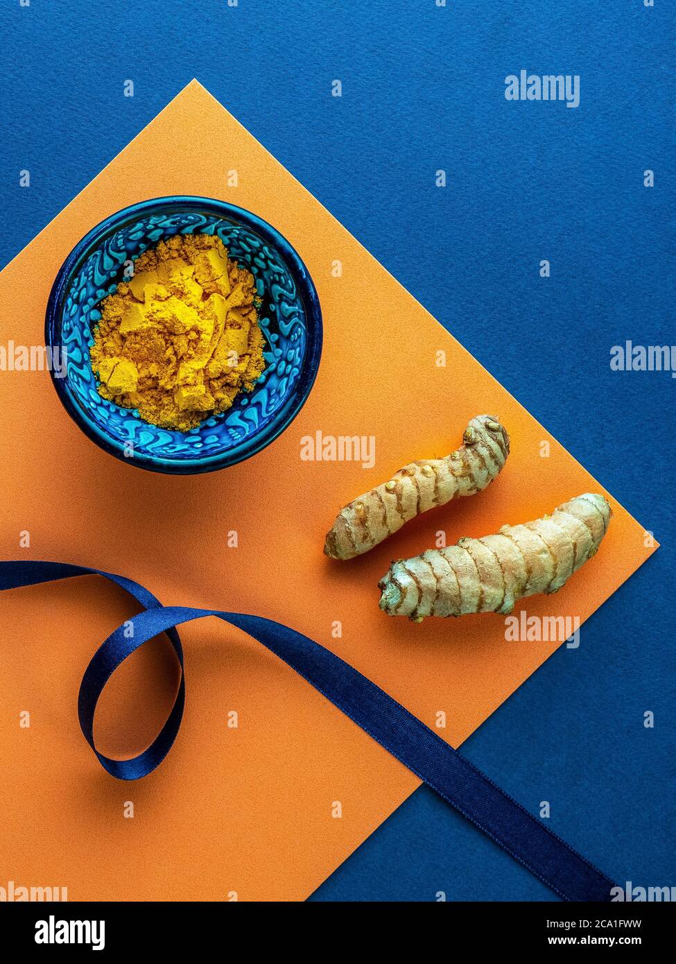 Turmeric (curcumin, Curcuma Longa Linn), powder in blue ceramic bowl ...
