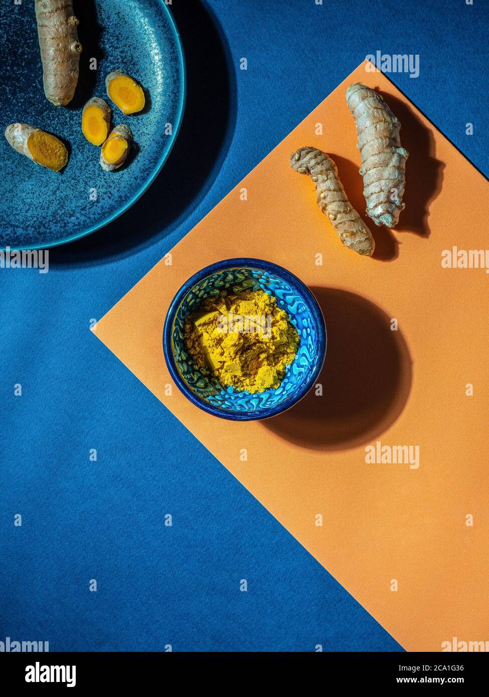 Turmeric (curcumin, Curcuma Longa Linn), powder in blue ceramic bowl ...