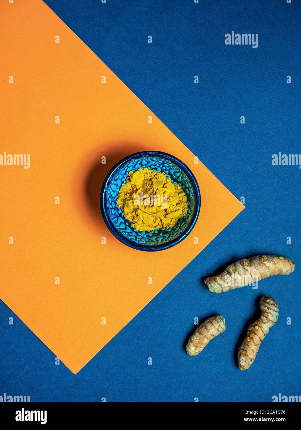 Turmeric (curcumin, Curcuma Longa Linn), powder in blue ceramic bowl ...