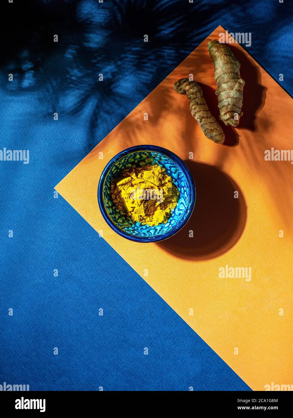 Turmeric (curcumin, Curcuma Longa Linn), powder in blue ceramic bowl ...