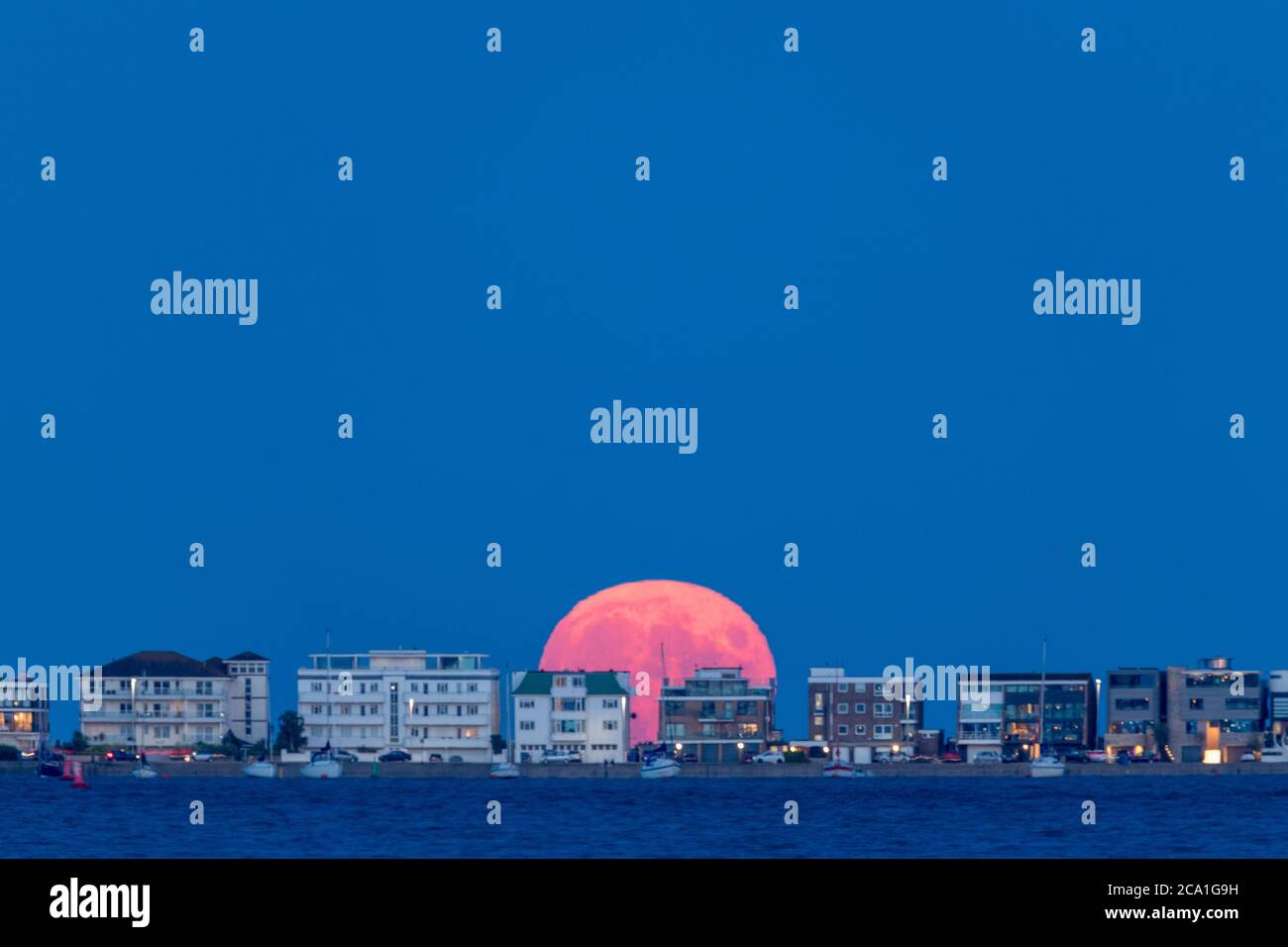 The August ("Sturgeon") full moon rising over the famous Millionaire's ...