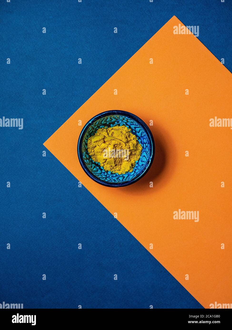 Turmeric (curcumin, Curcuma Longa Linn), powder in blue ceramic bowl ...