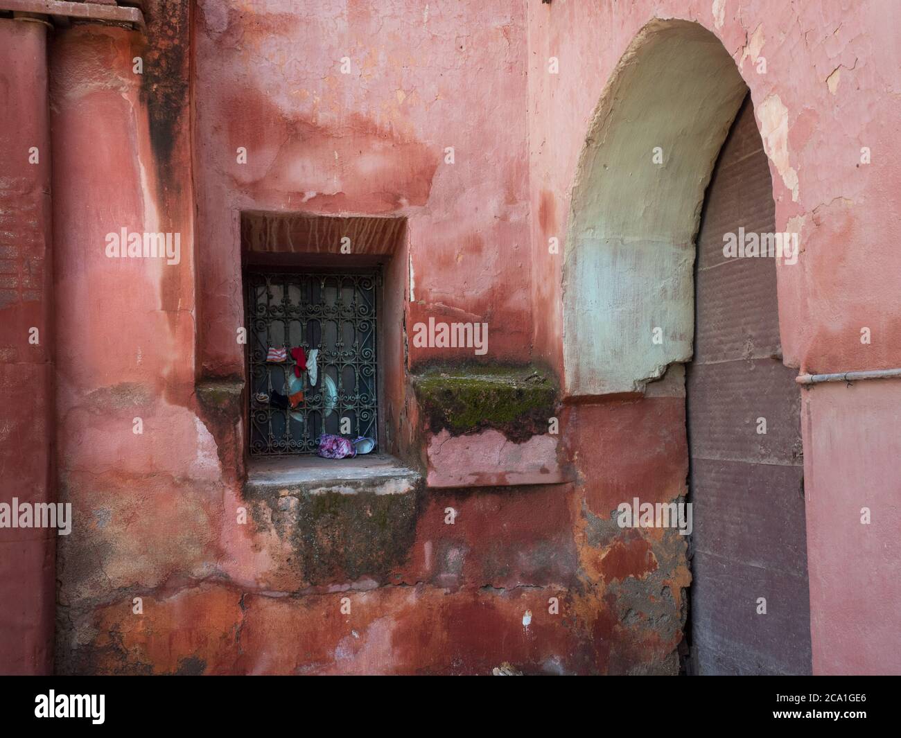 Ancient red wall with mold and arch door in the medina of Marrakesh ...
