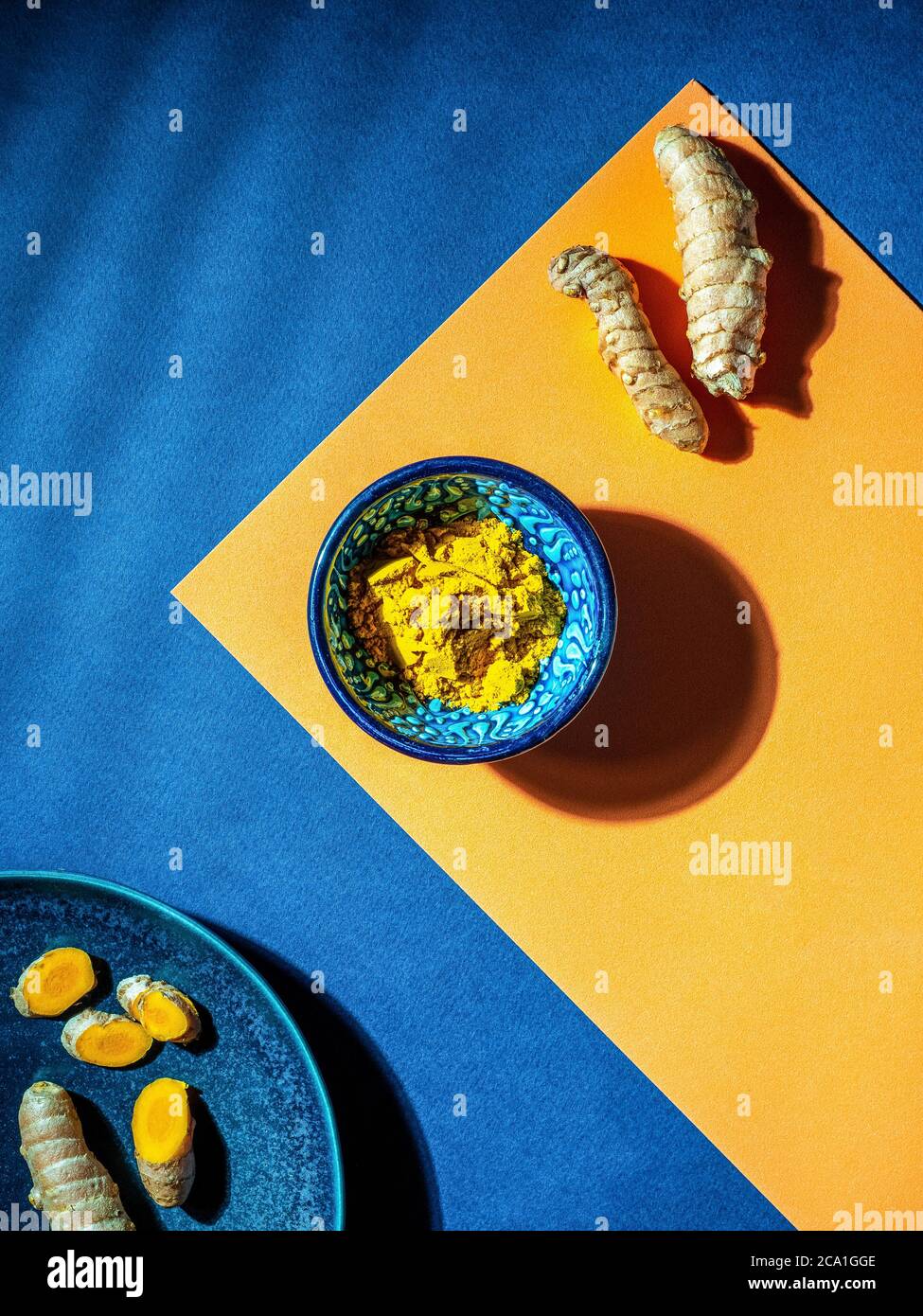 Turmeric (curcumin, Curcuma Longa Linn), powder in blue ceramic bowl ...