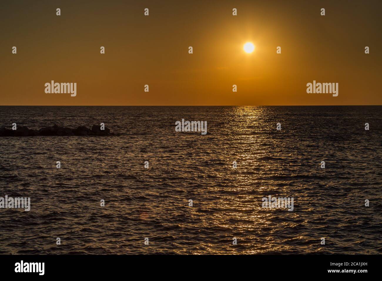 sun shining on sea waves at sunset Stock Photo - Alamy