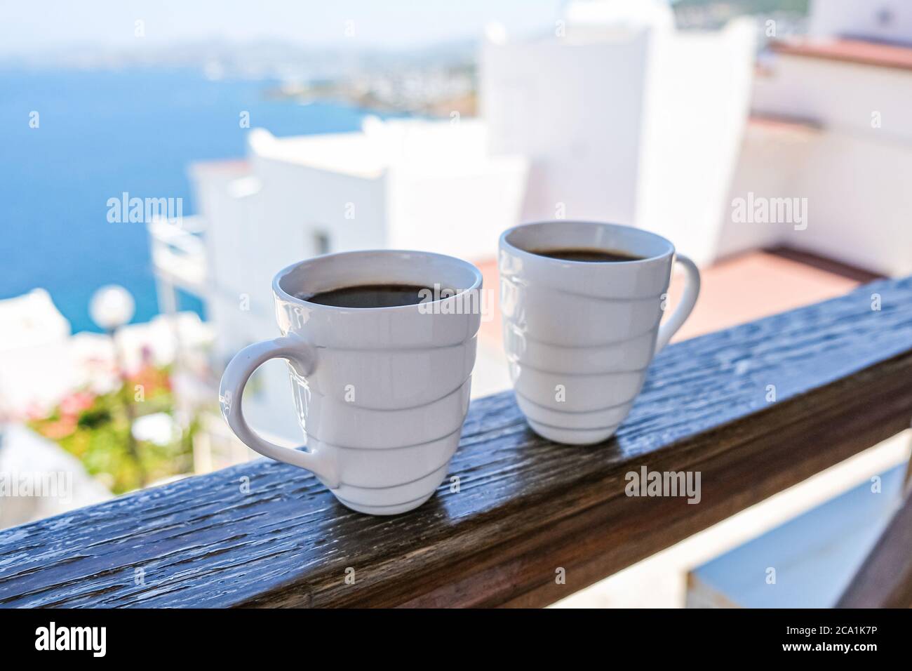 two coffee cup coffee cups in wooden balcony terrace with sea view ...