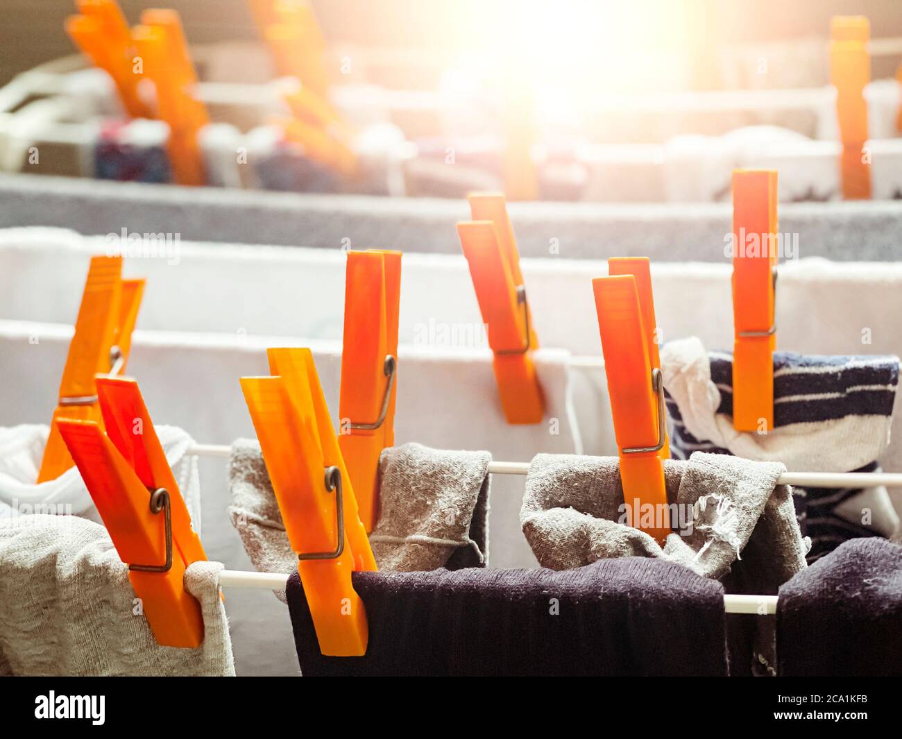 a group of orange clothes pegs on a drying rack to dry the laundry ...