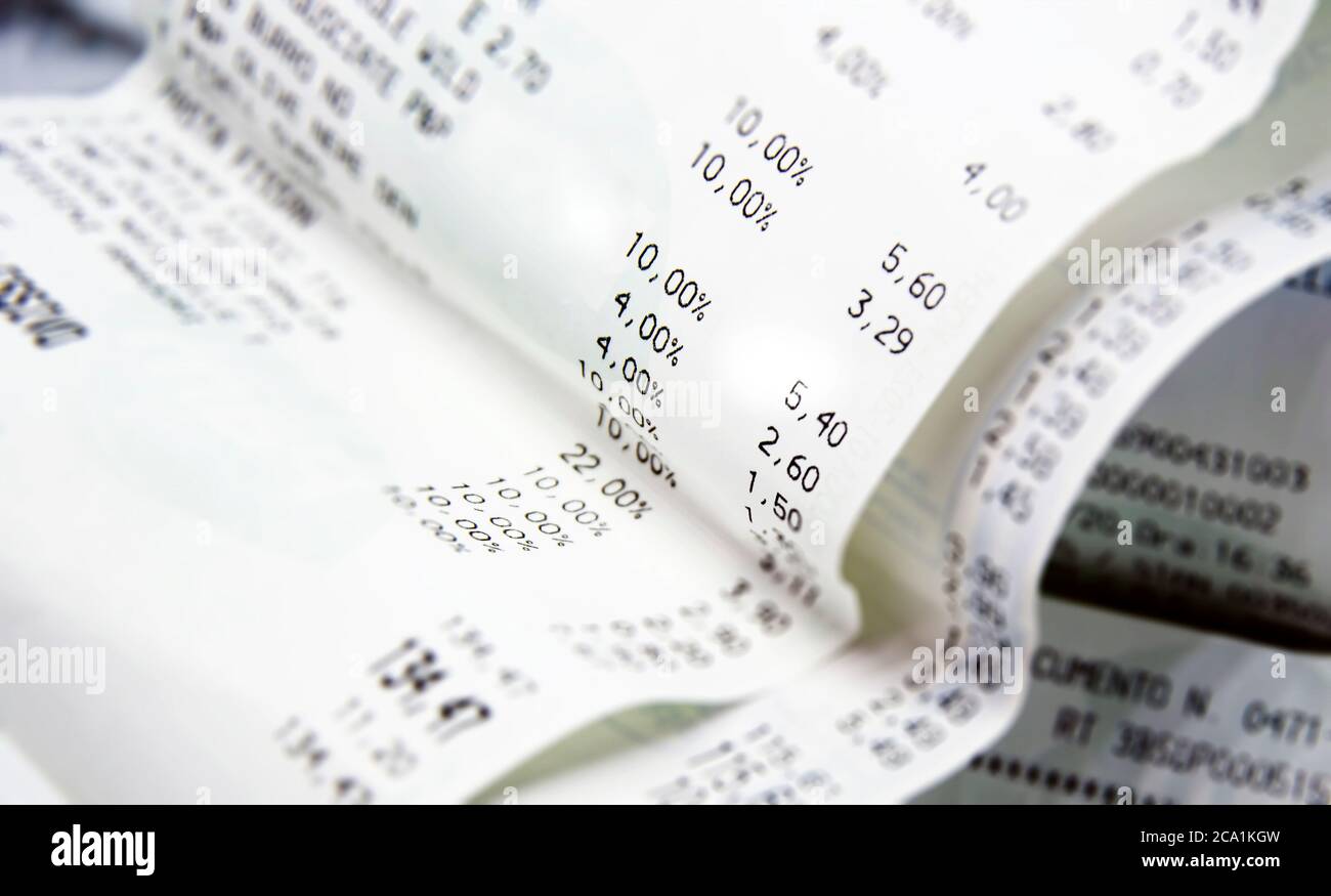 a paper receipt with the list of economic issues. Business and ...