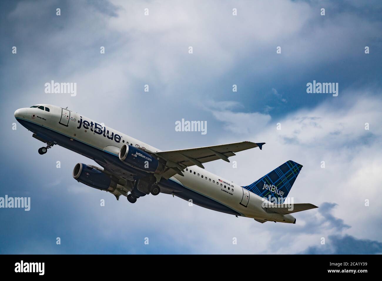Photo of a Jetblue airplane on sky background blue and clouds Stock ...