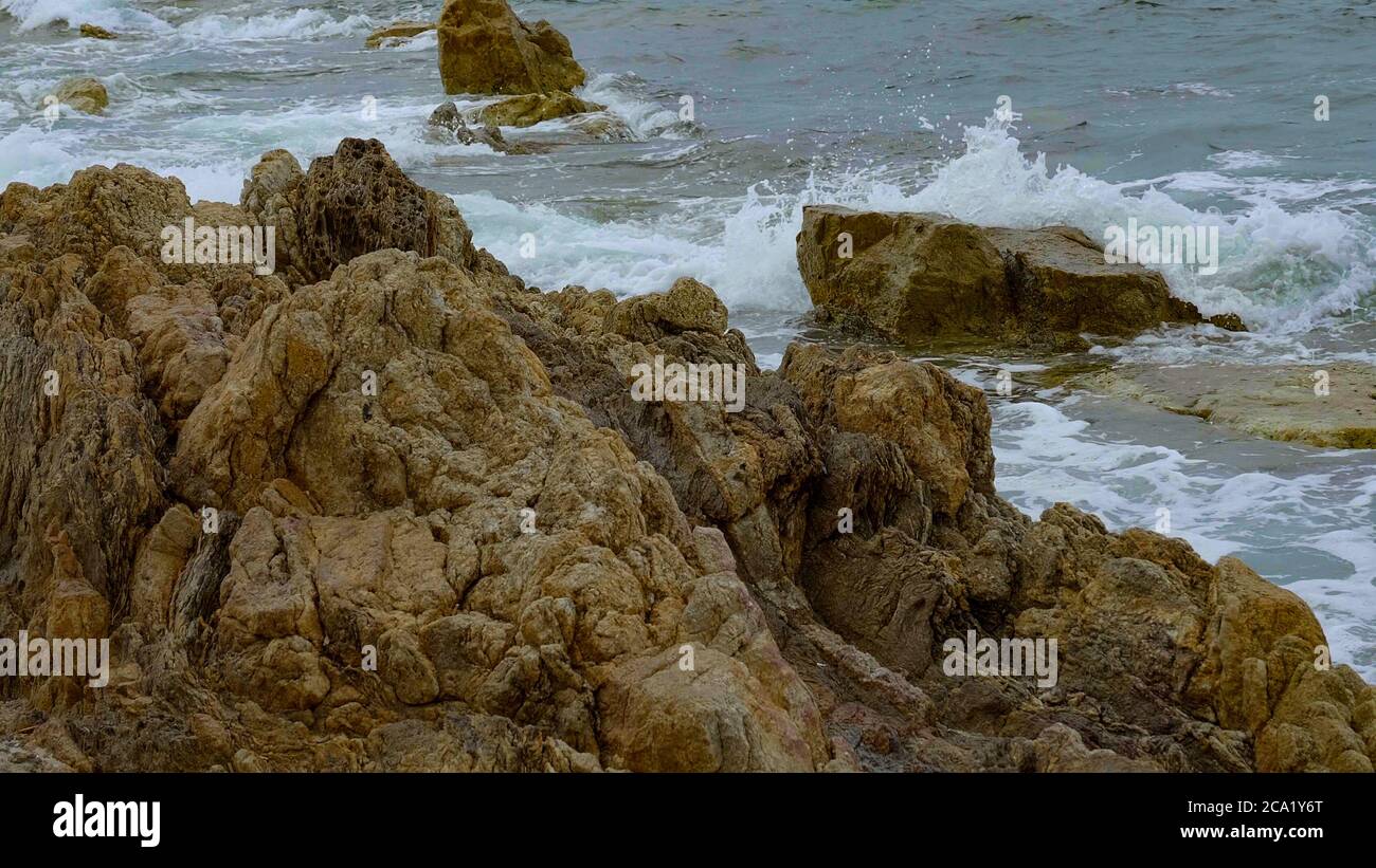 Waves hit against rocks at the Mediterranian sea Stock Photo - Alamy