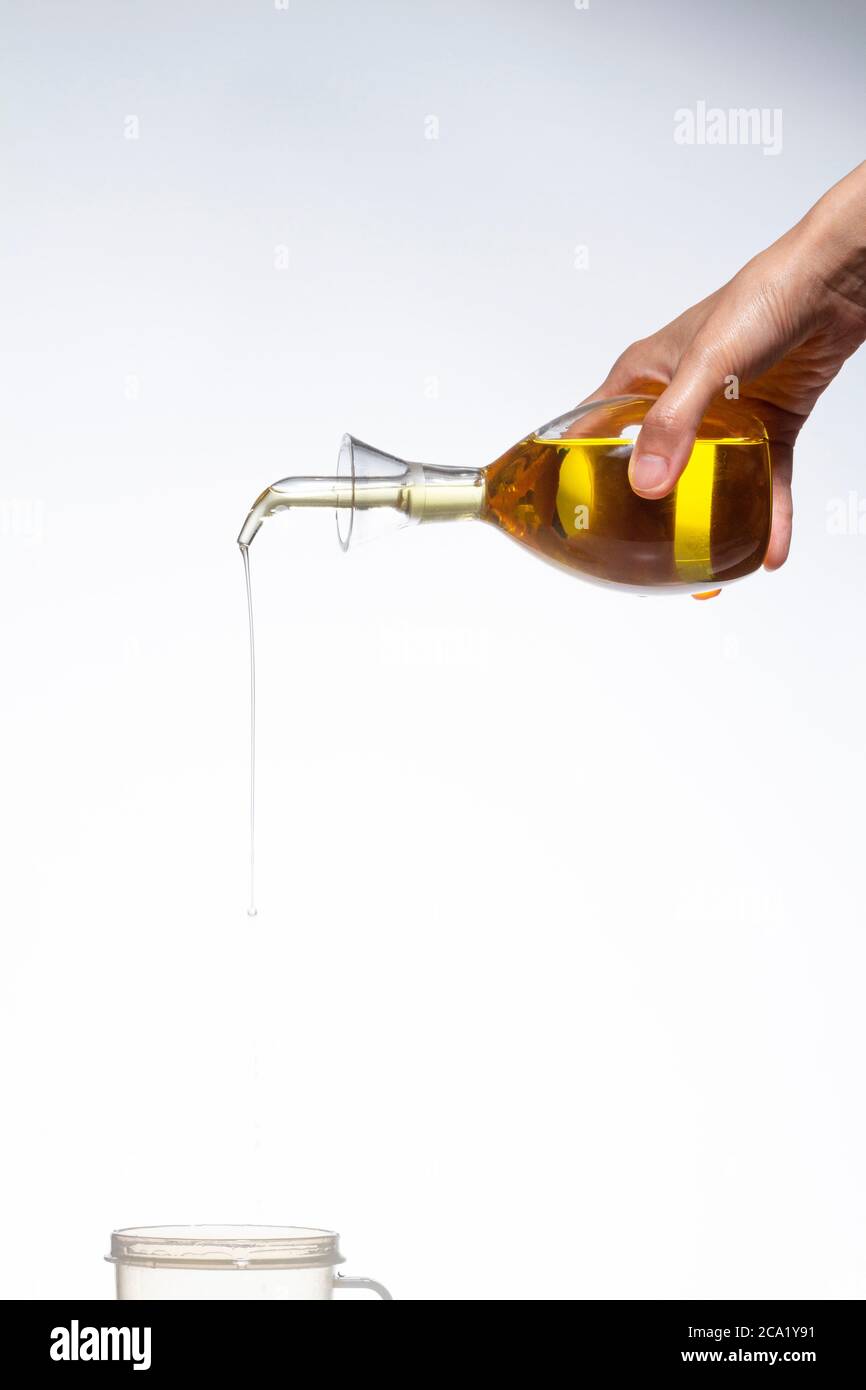 Oil pouring from spoon hi-res stock photography and images - Alamy
