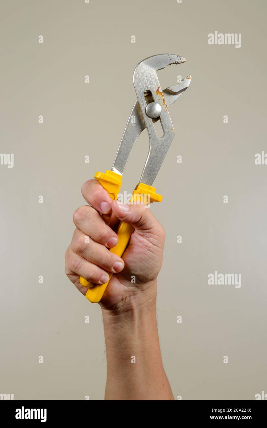 industry worker hand holding mechanical tool Stock Photo - Alamy