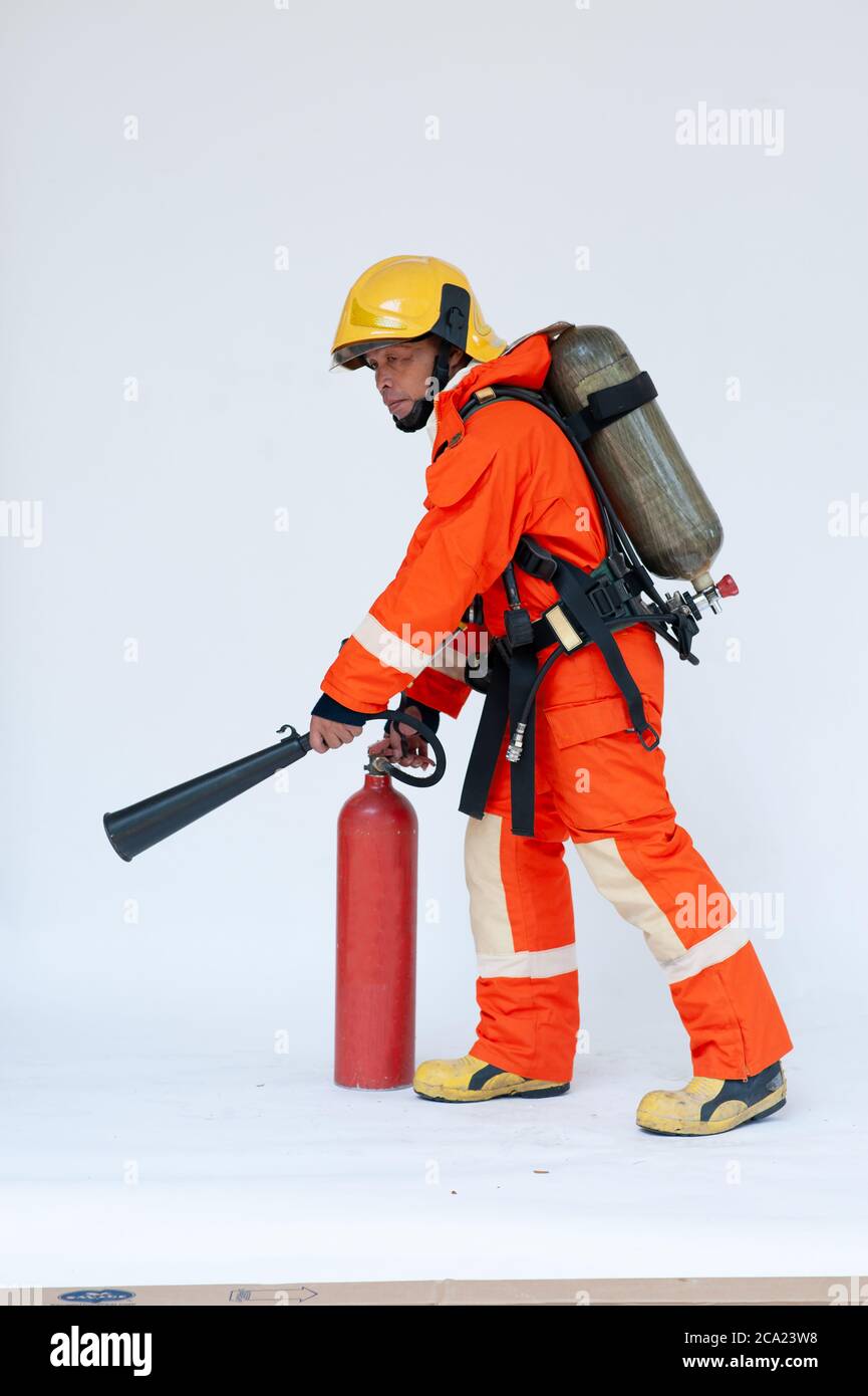 A portrait of Asian male firefighter in red protective uniform, mask ...