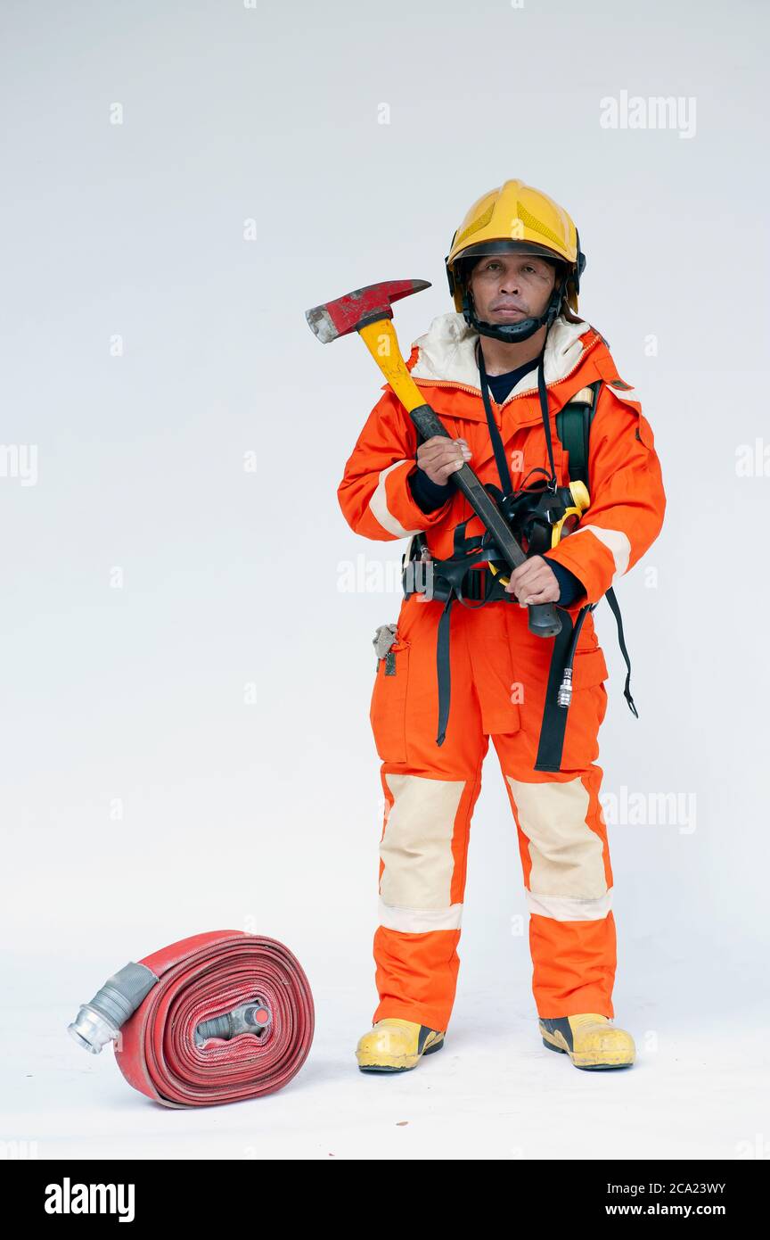 A portrait of Asian male fireman in red protective clothing, mask and ...