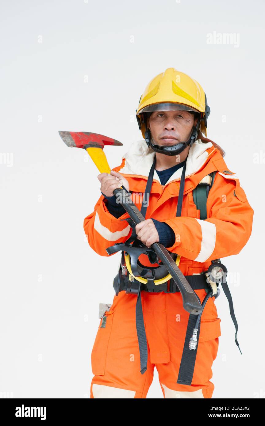 A portrait of Asian male fireman in red protective clothing, mask and ...