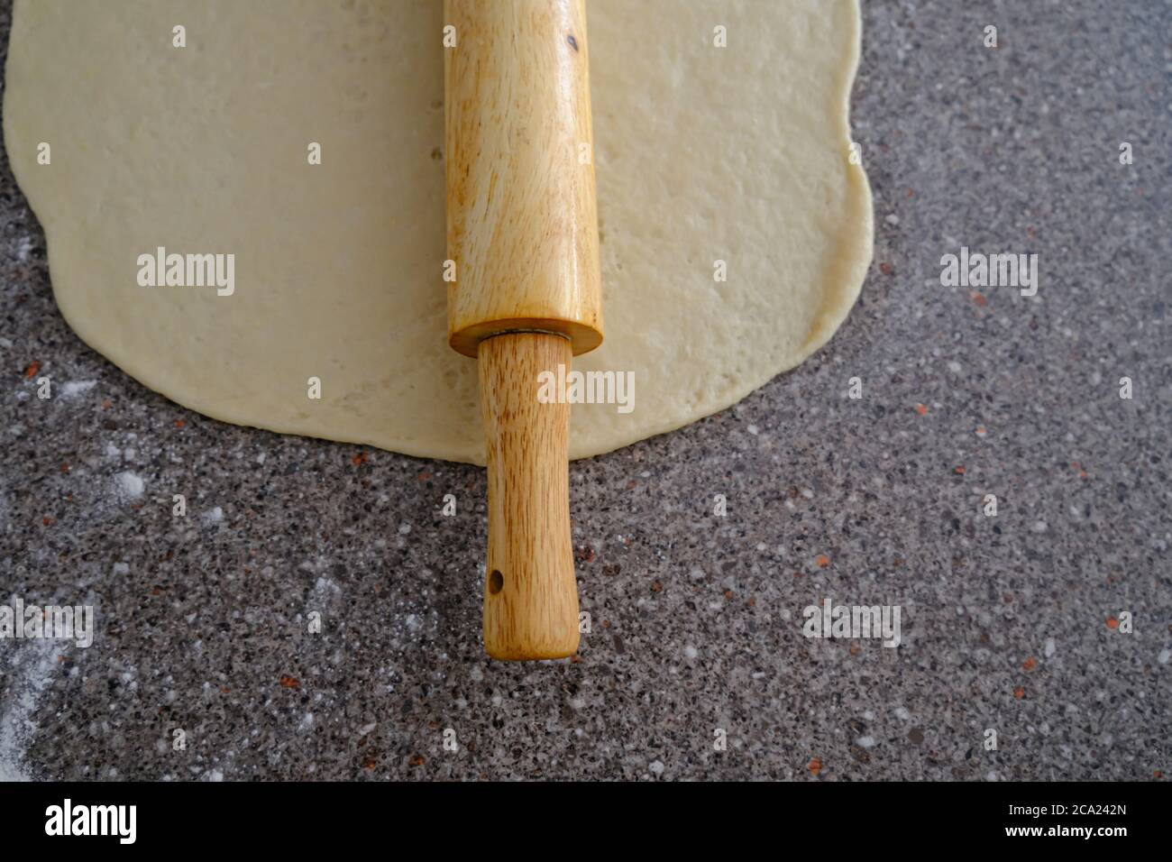 Rolling pin with dough to prepare Nigerian Chin Chin Stock Photo - Alamy