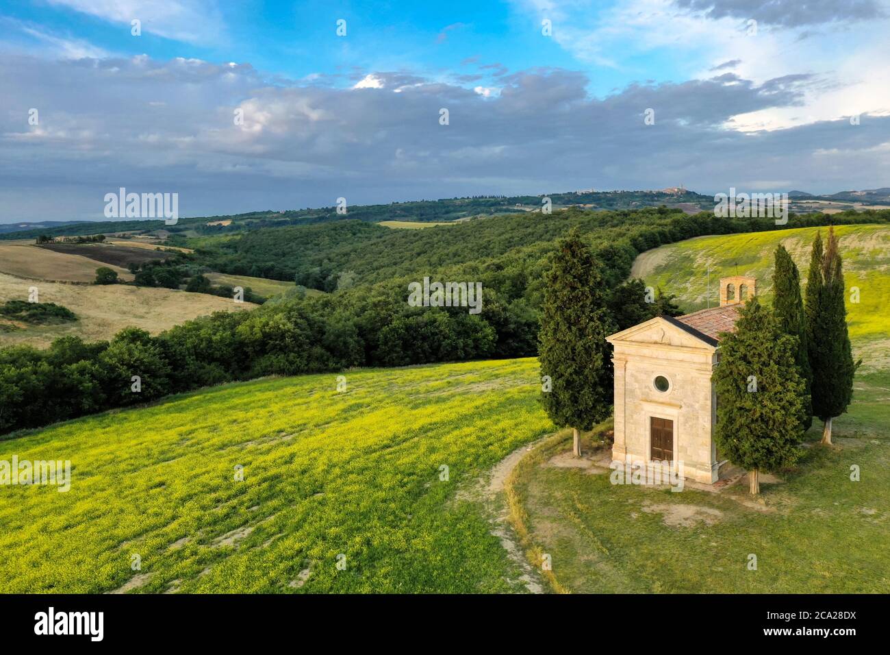 Iconic Tuscanian landscape, with a tiny ancient chapel surrounded by ...