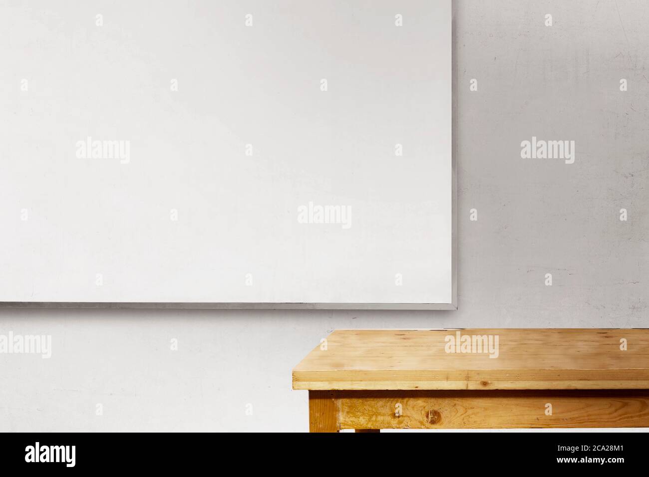 Desk and whiteboard inside the classroom with white wall background ...