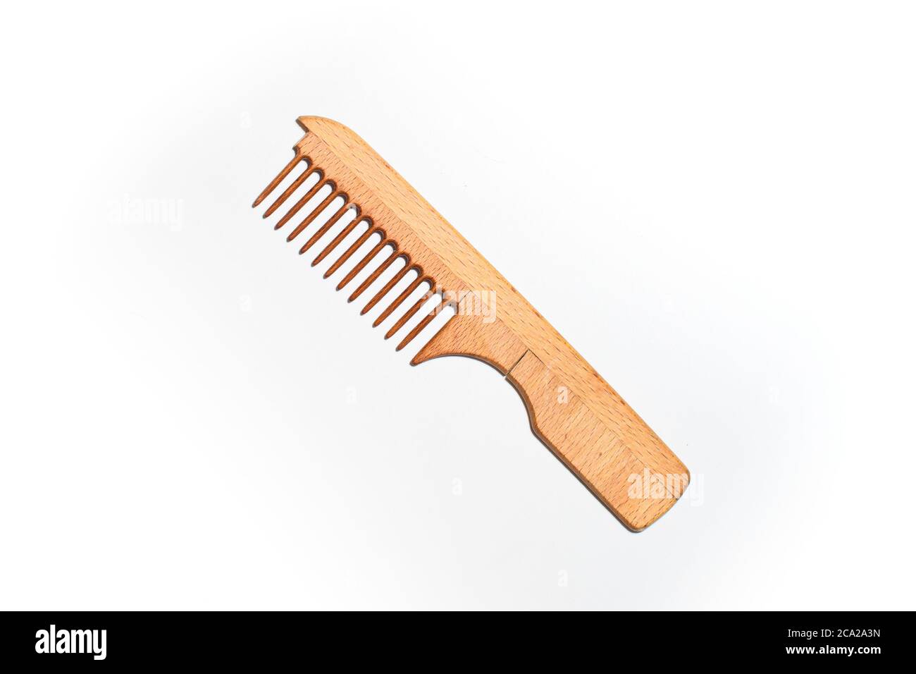 Wooden comb with handle on a white background Stock Photo - Alamy