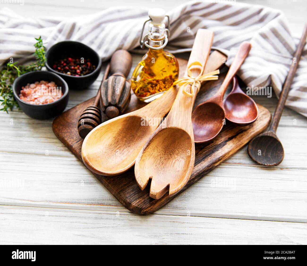 Wooden cutlery kitchen ware on a white wooden background Stock Photo ...