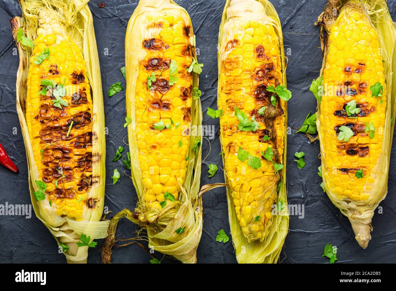 Grilled sweet corn with sauce and spicy.Summer vegan snack Stock Photo ...