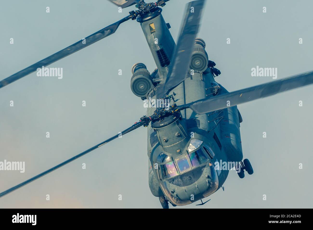 Military combat and war with Chinook helicopter close up flying through ...