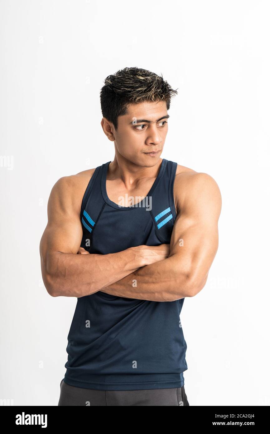 muscular man standing wearing gym clothes with crossed hands look ...