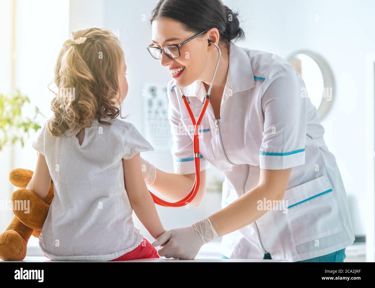 Doctor examining a child in a hospital Stock Photo - Alamy