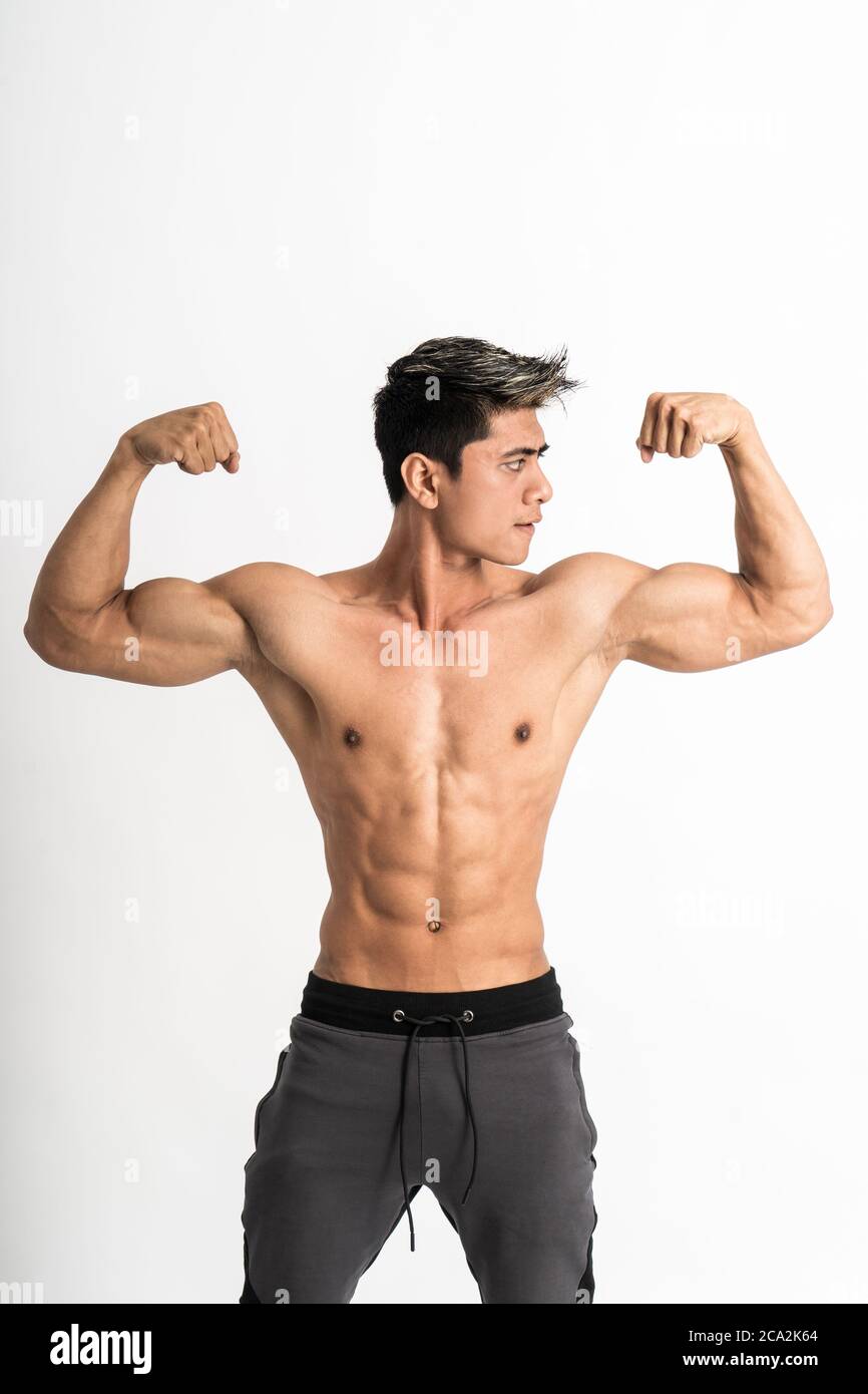 young man showing muscular biceps stand facing forward on isolated ...