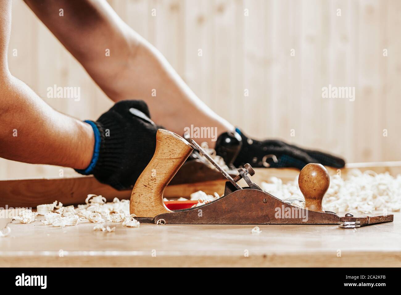 Close up of the man working with hand jack plane. Work with wooden ...