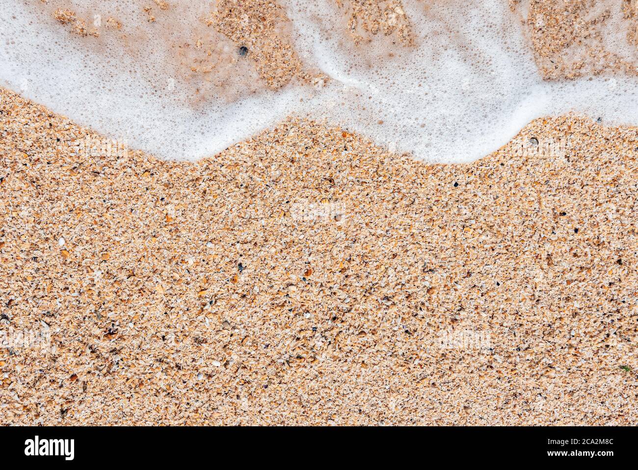 Sea sand with water splash Stock Photo - Alamy