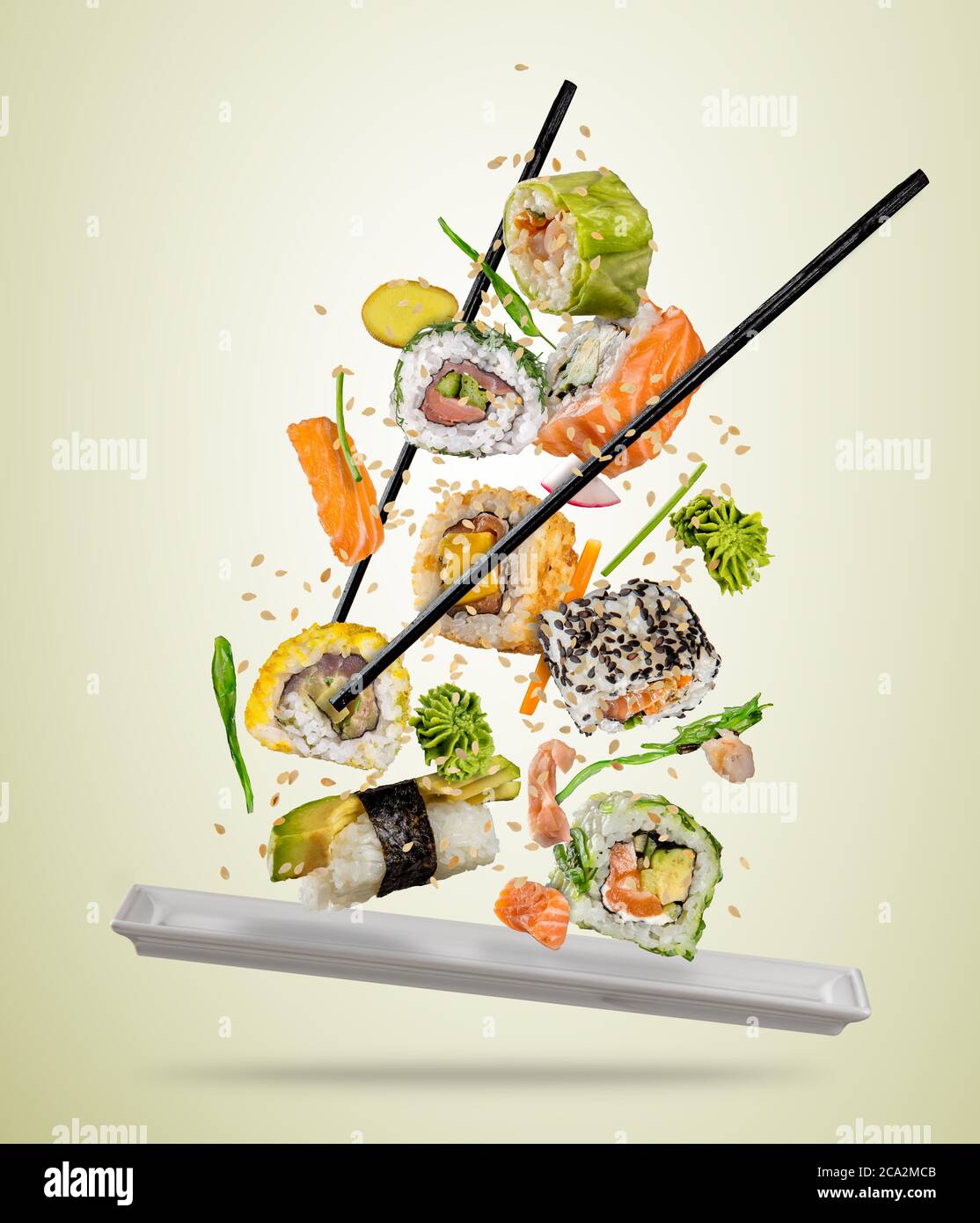 Flying sushi pieces served on plate, separated on colored background ...