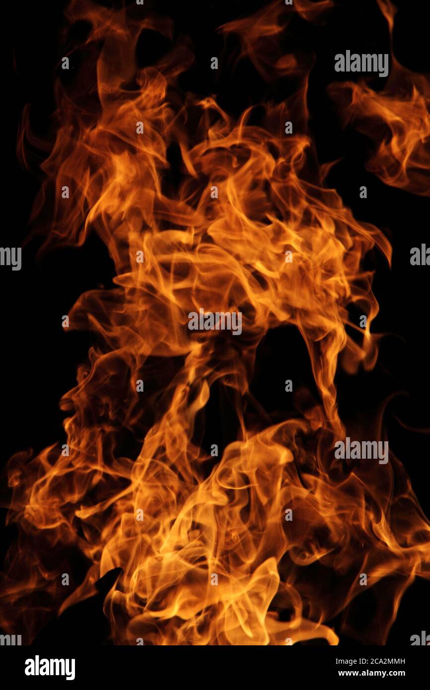 red and orange fire isolated on the black background Stock Photo - Alamy