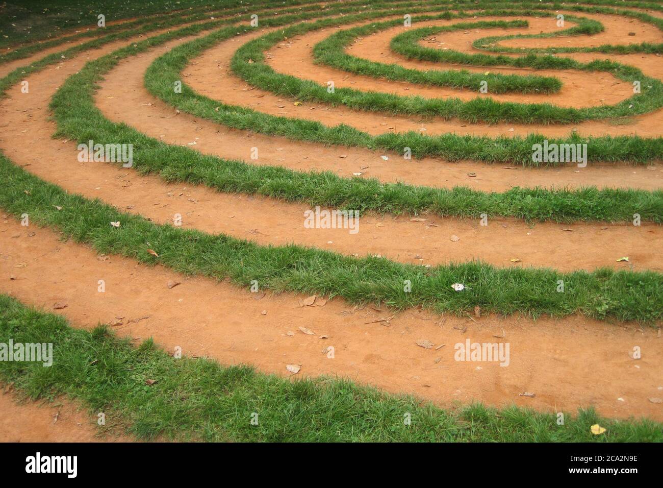 grass labyrinth in the orange sand as nice background Stock Photo - Alamy