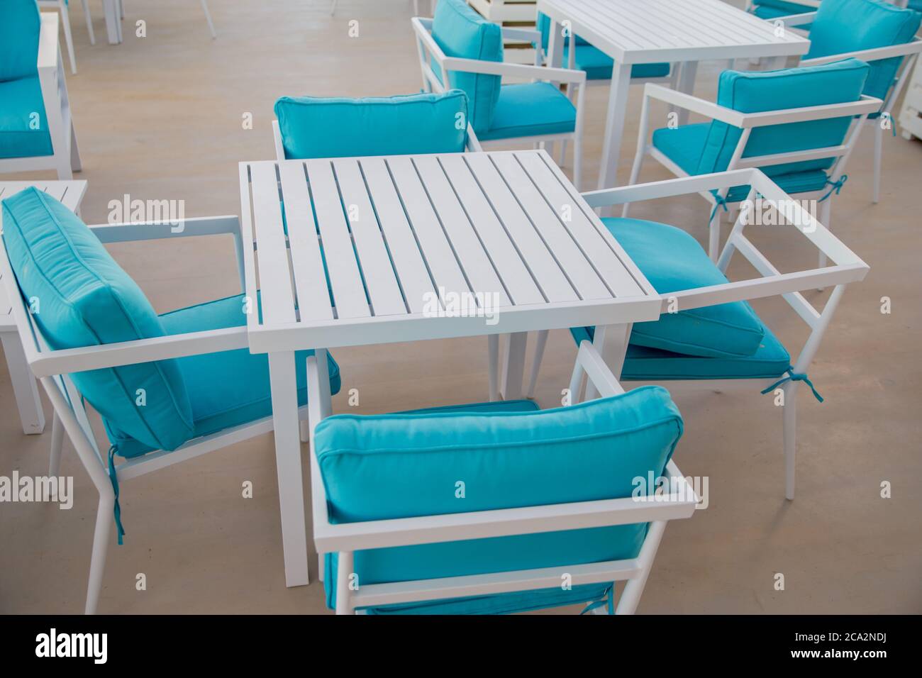 chairs and tables in beach restaurant Stock Photo - Alamy